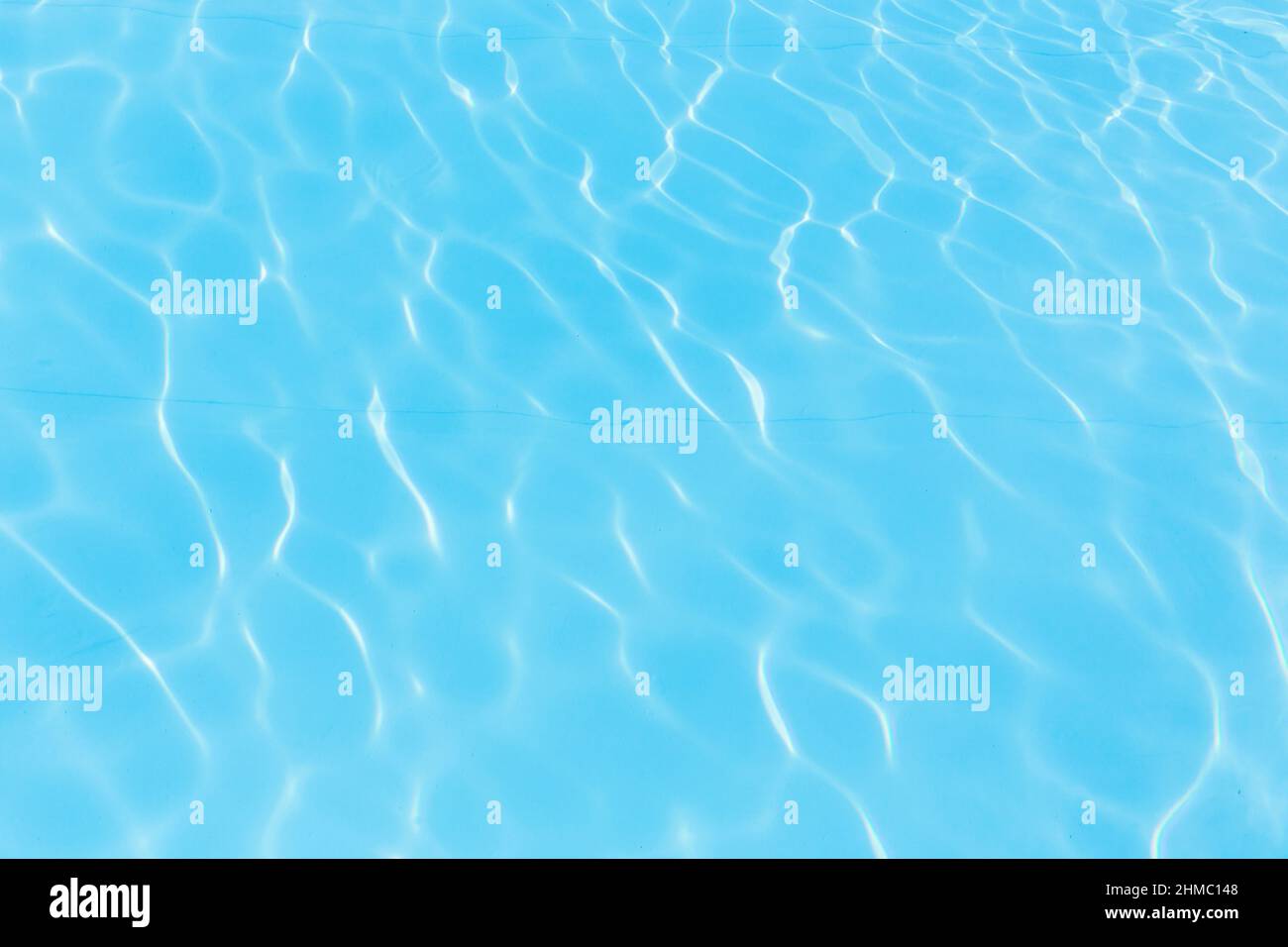 Blue pool water with sun reflections background Stock Photo - Alamy