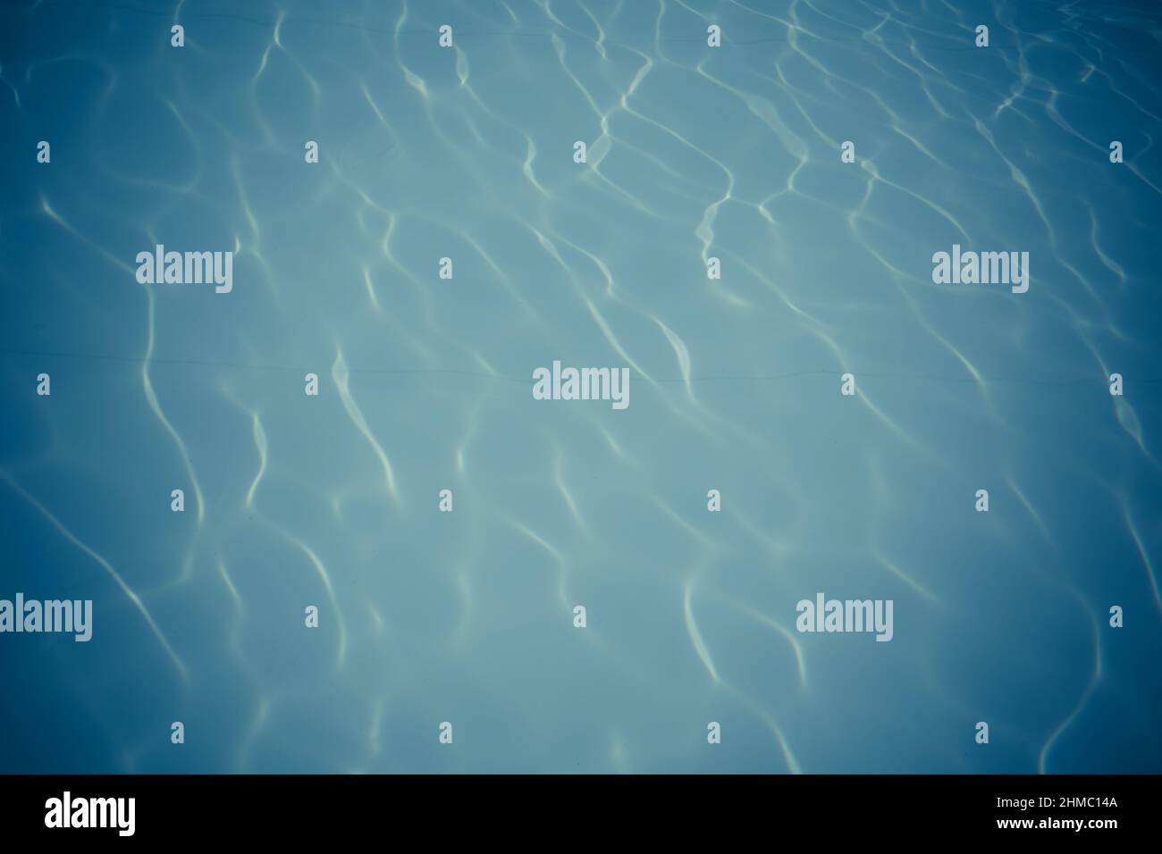 Blue pool water with sun reflections background Stock Photo - Alamy