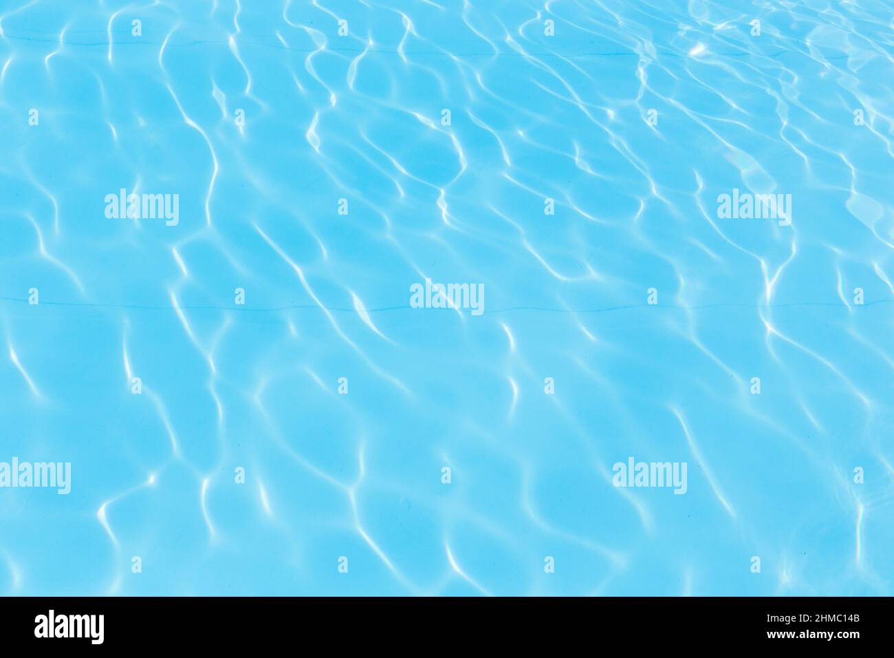 Blue pool water with sun reflections background Stock Photo - Alamy