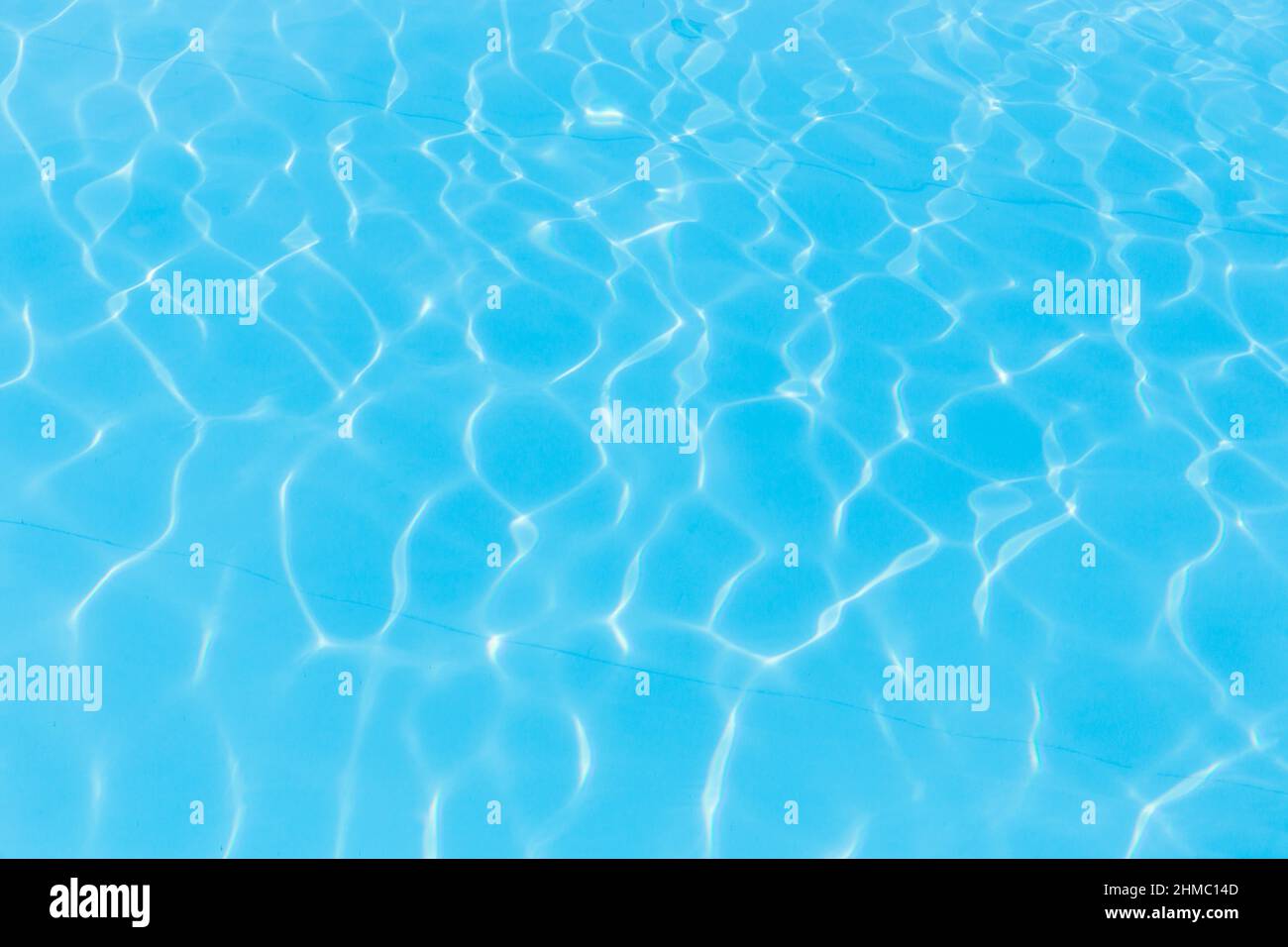 Blue pool water with sun reflections background Stock Photo - Alamy