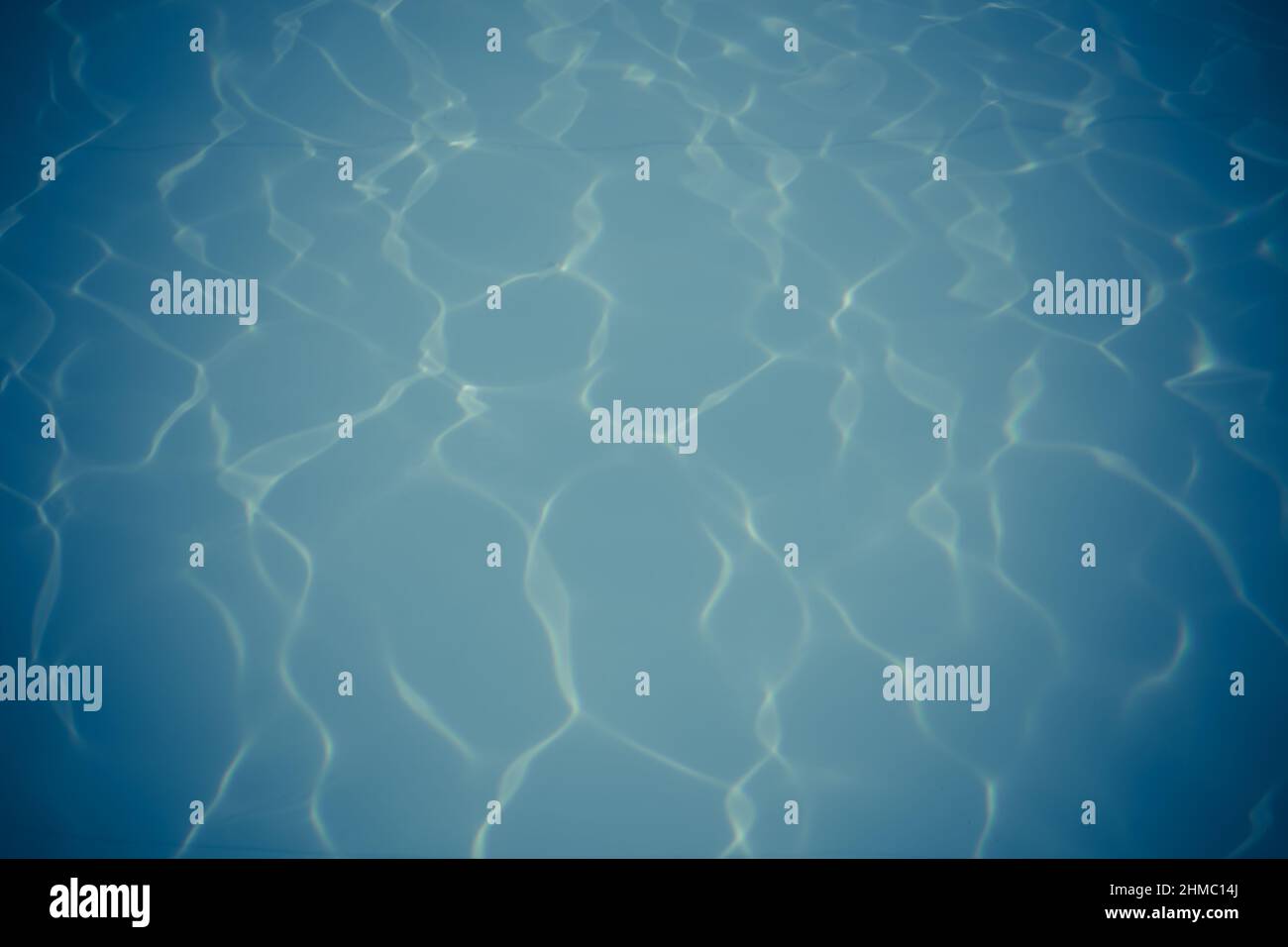 Blue pool water with sun reflections background Stock Photo - Alamy