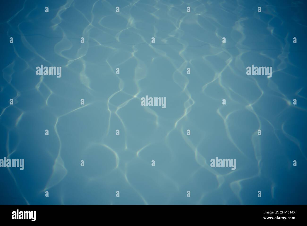 Blue pool water with sun reflections background Stock Photo - Alamy
