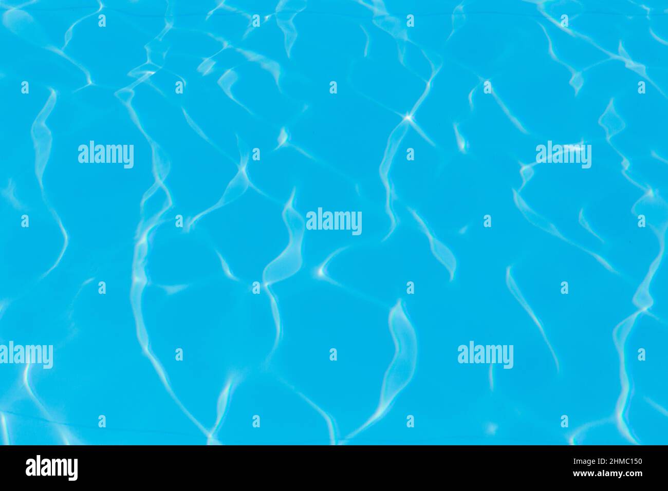 Blue pool water with sun reflections background Stock Photo - Alamy