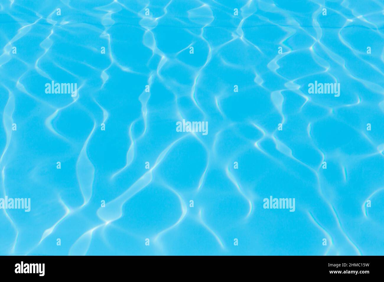 Blue pool water with sun reflections background Stock Photo - Alamy