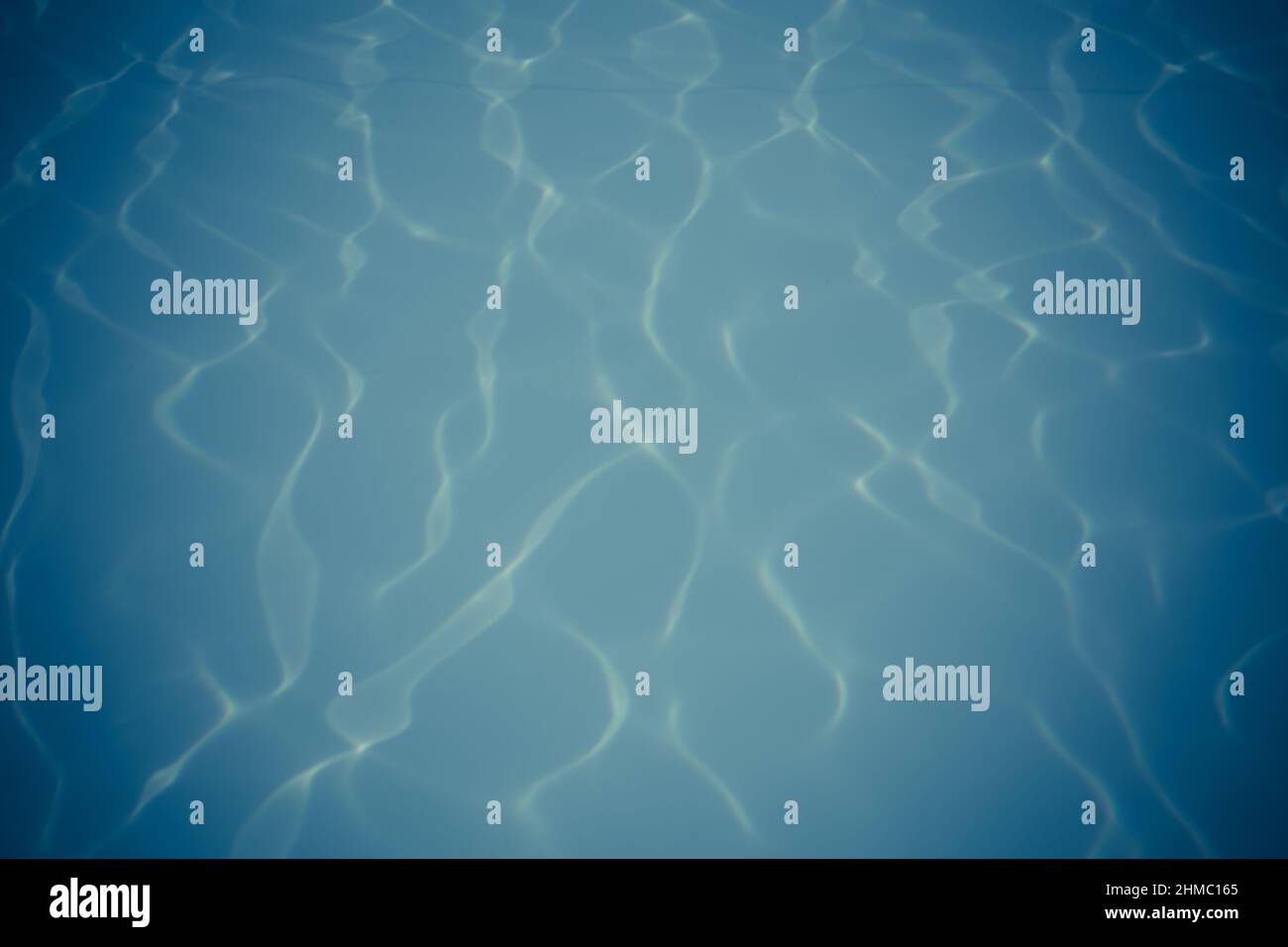 Blue pool water with sun reflections background Stock Photo - Alamy