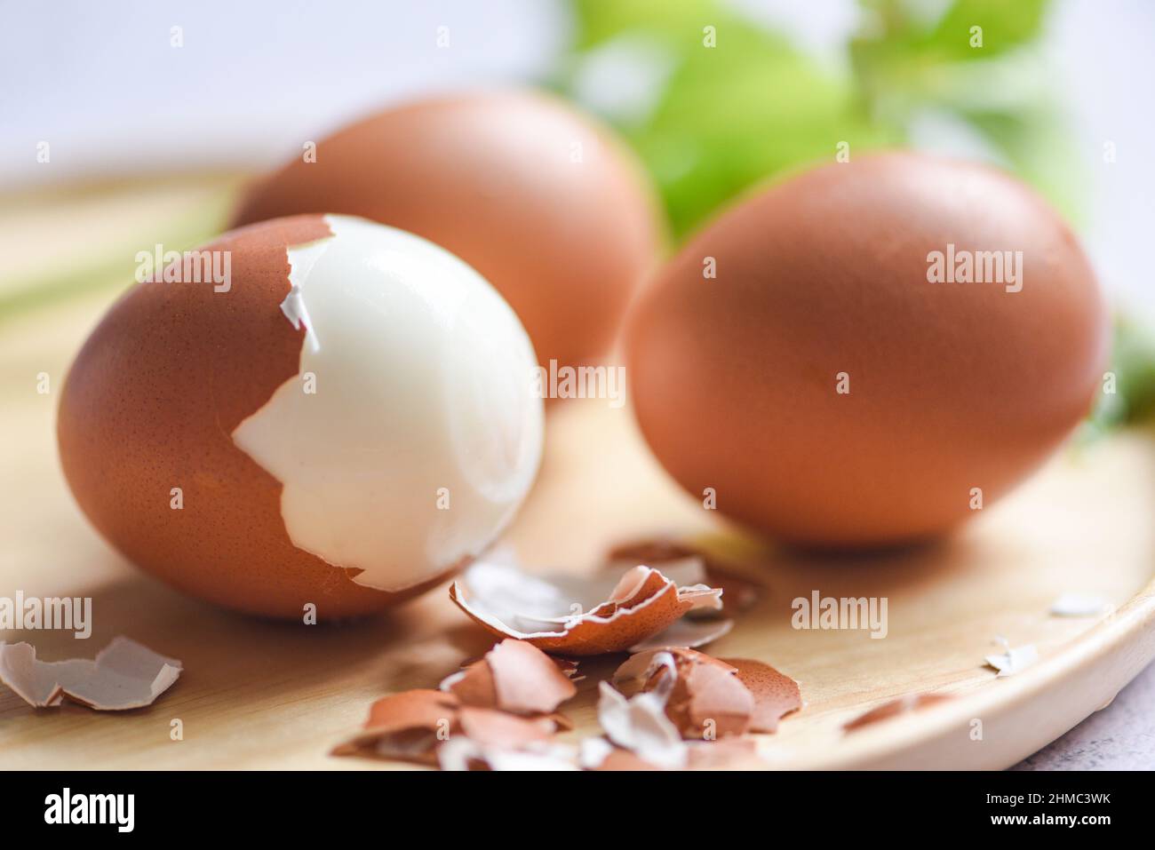 Peeled eggs menu food boiled eggs in a wooden plate decorated with leaves green vegetable and ...