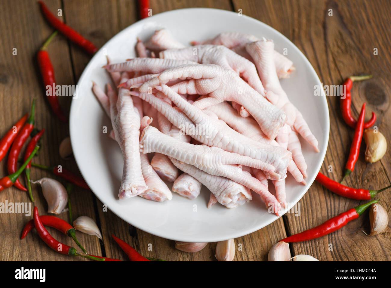 chicken feet on white plate with herbs and spices chili garlic, Fresh ...