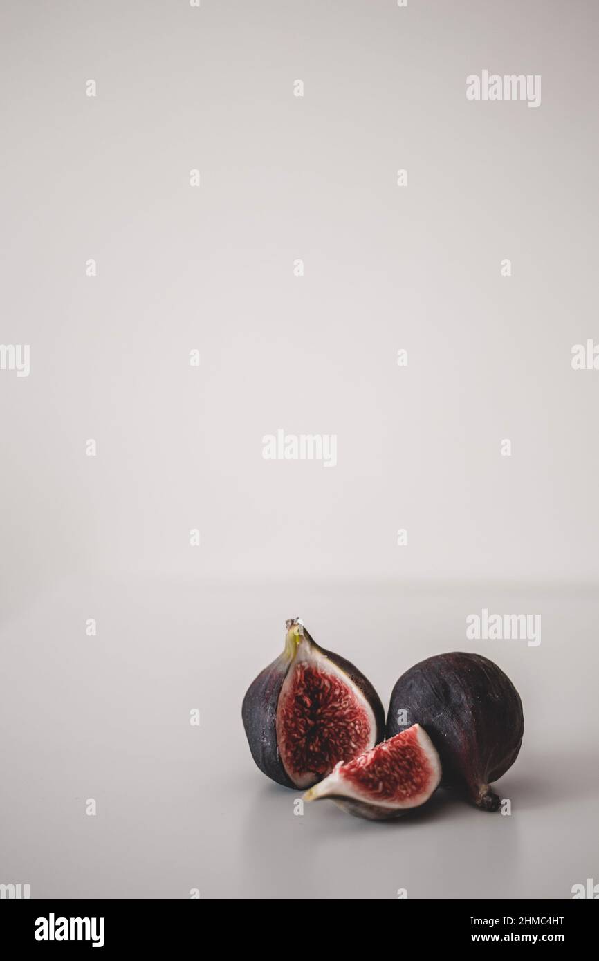 Two figs minimalism closeup. One fig in a cut on corner parts Stock ...