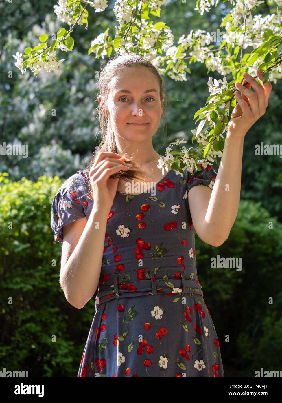 Beautiful Young woman without makeup in a spring park among flowering ...