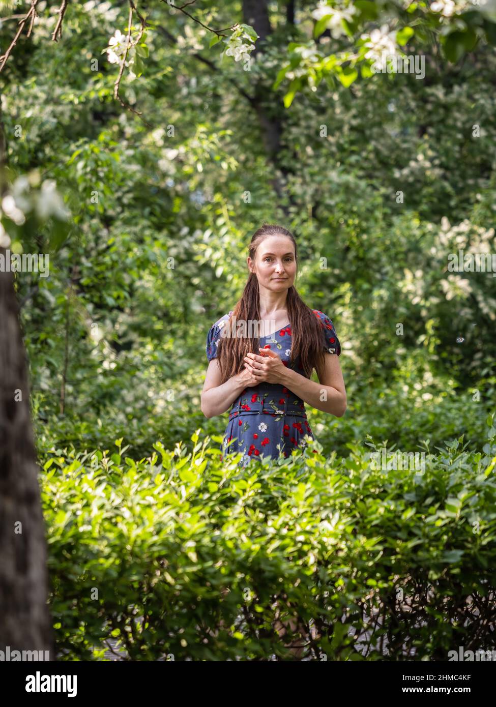 Beautiful Young woman without makeup in a spring park among flowering ...