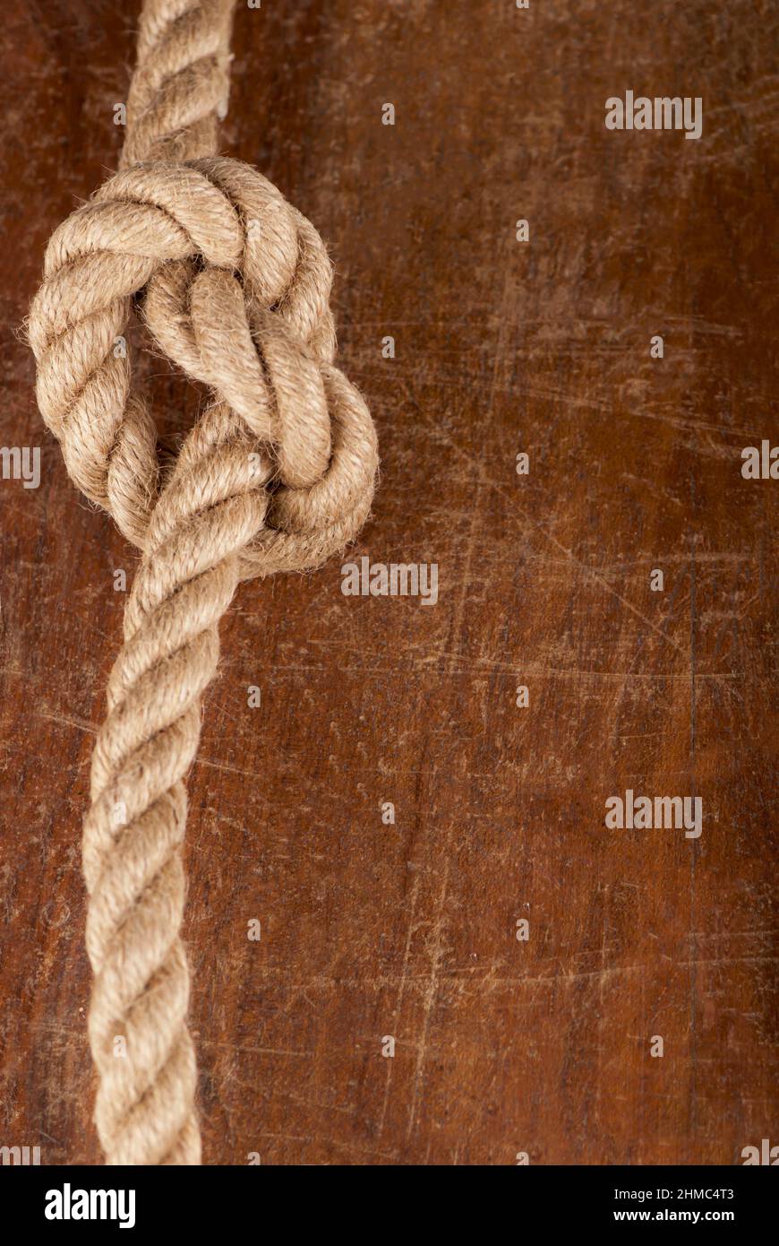 Rope with Reef Knot on Wood Texture Background Stock Photo - Alamy
