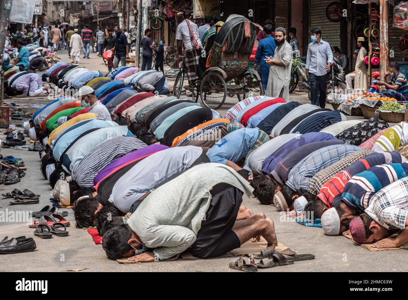 Devotees attend Jumu'ah in the streets, a Muslim prayer that is ...