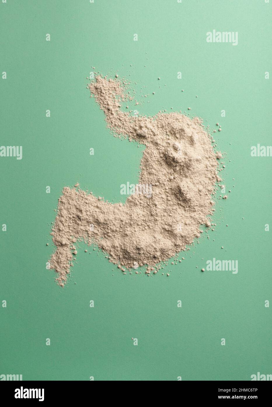 Healing clay in the form of stomach on green background, health care ...