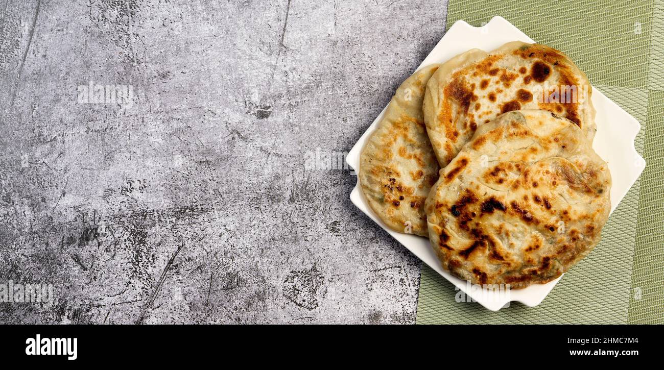 Rou bing - chinese meat pancakes on a square plate on a dark background ...