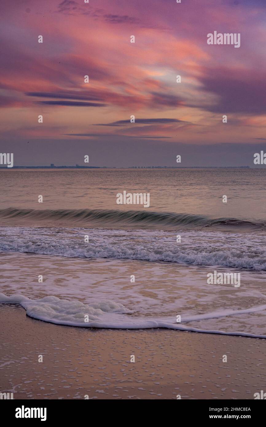 Scenic portrait of the colorful sky across the sea during twilight ...