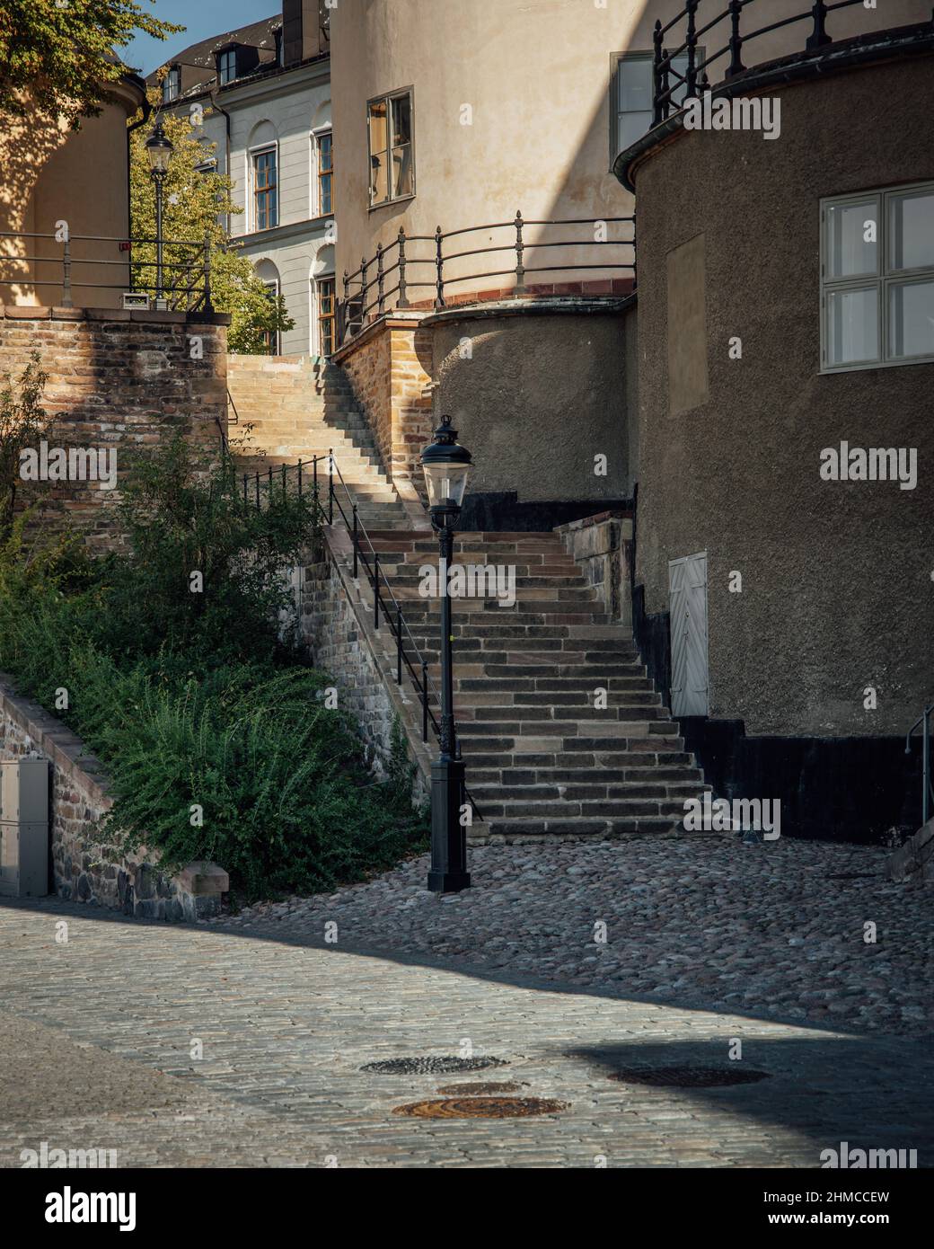 View of urban stairs between old buildings with tiled floor Stock Photo ...