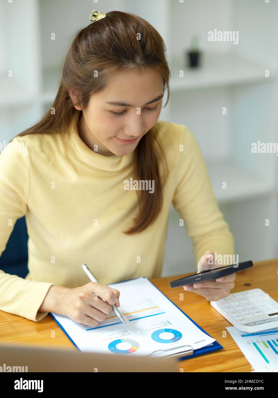 Attractive female financial analysts or financial consultant analysing ...