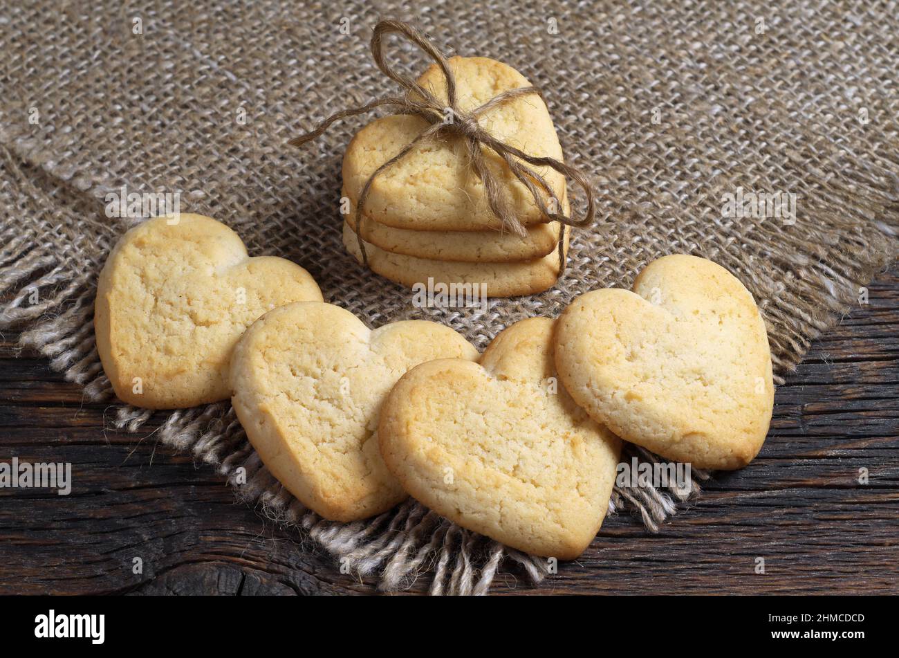 Heart-shaped shortbread cookies tied with a rope and several separate ...