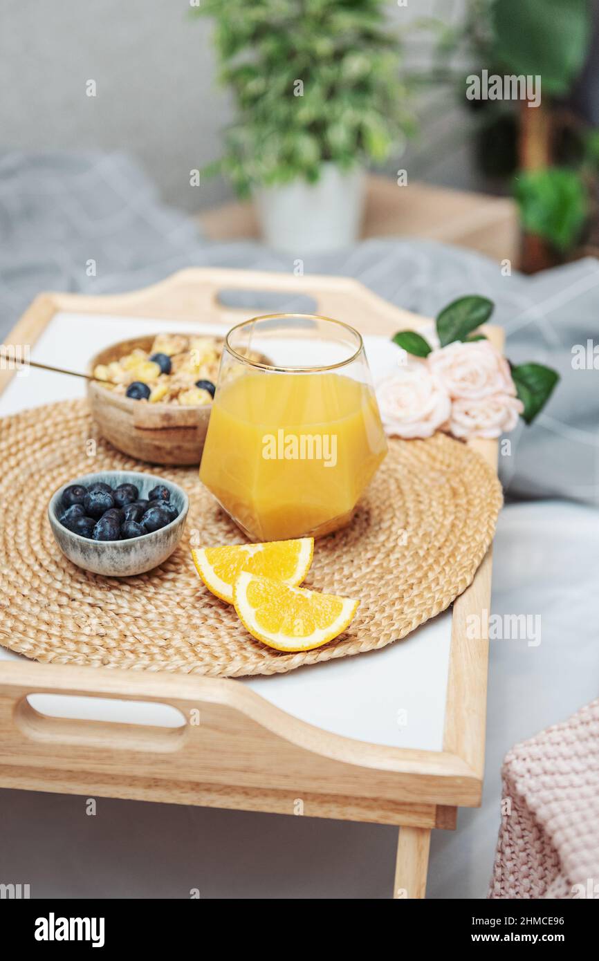 Healthy breakfast. Orange juice, fruits and bowl with granola on a tray ...