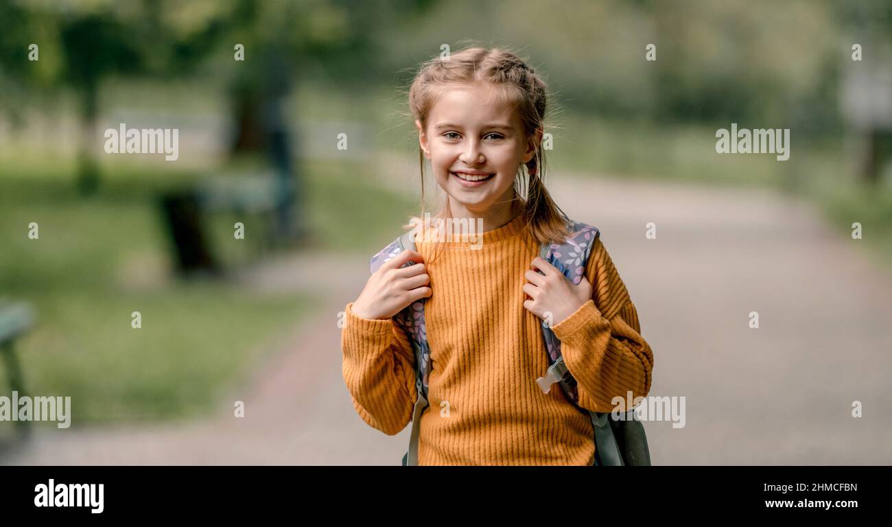Schoolgirl with backpack outdoors Stock Photo - Alamy