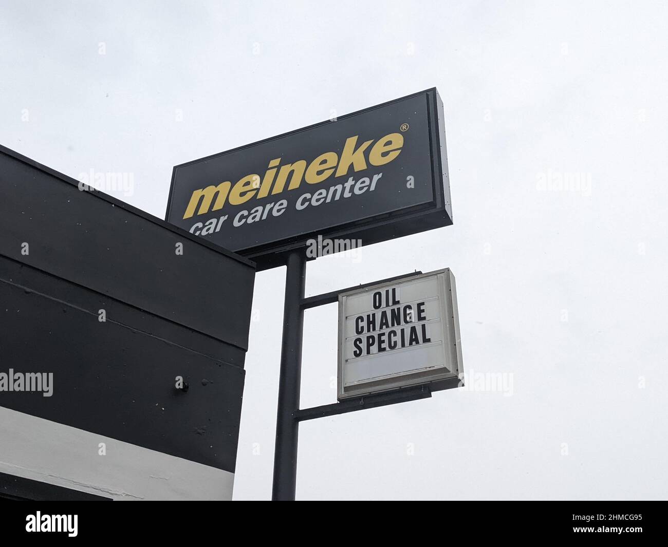 Meineke Car Care Center signboard on a building over a parking lot ...