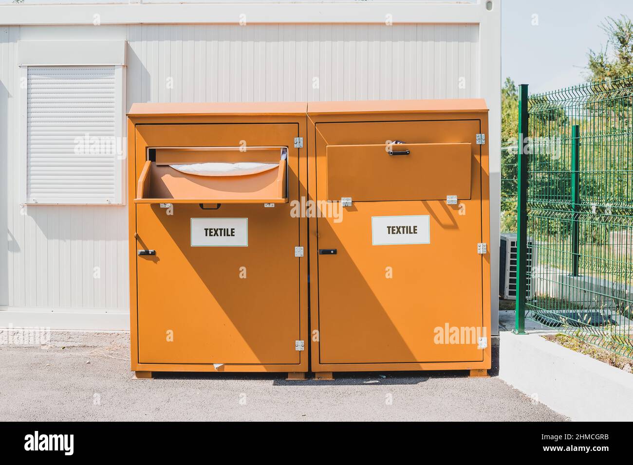 Textile waste container at waste management centre. Cloth recycling ...