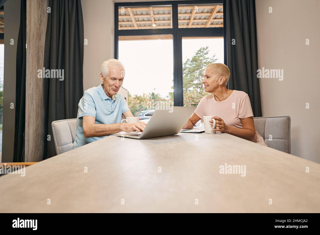 Positive delighted aged man looking at screen of laptop Stock Photo - Alamy