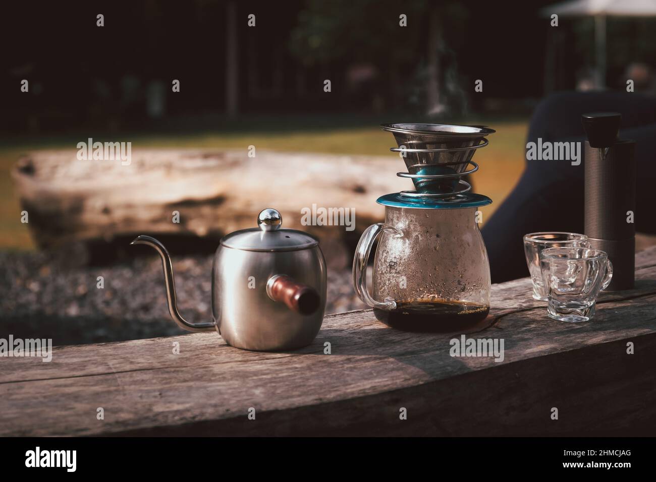Coffee maker is placed on top of wooden chair in camping area Stock ...