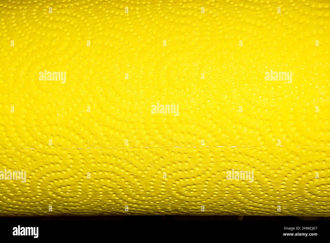 Abstract background texture of perforated paper in yellow color. Copy ...