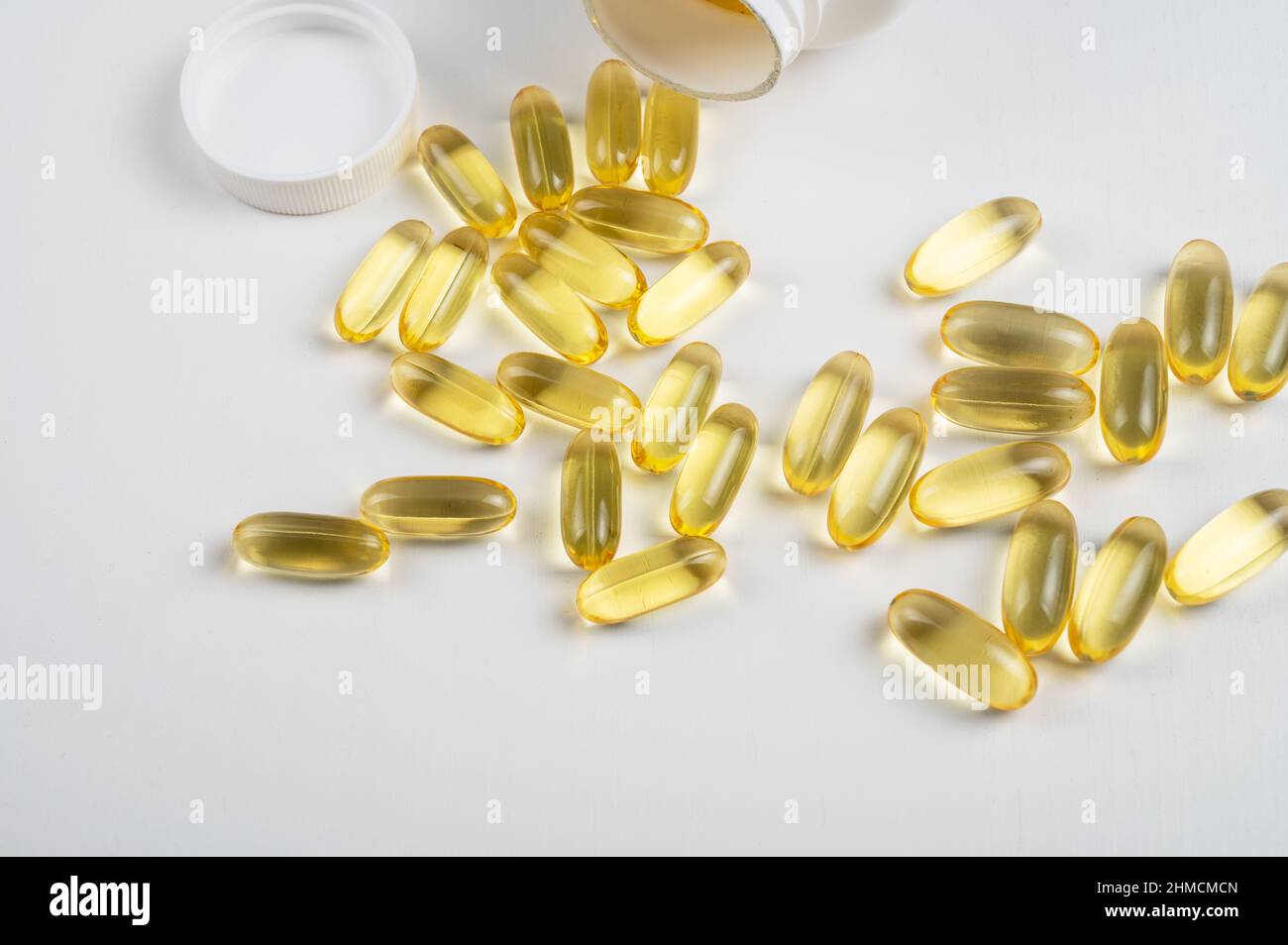 Gold fish oil isolated on white background. Pile of fish oil with Omega ...