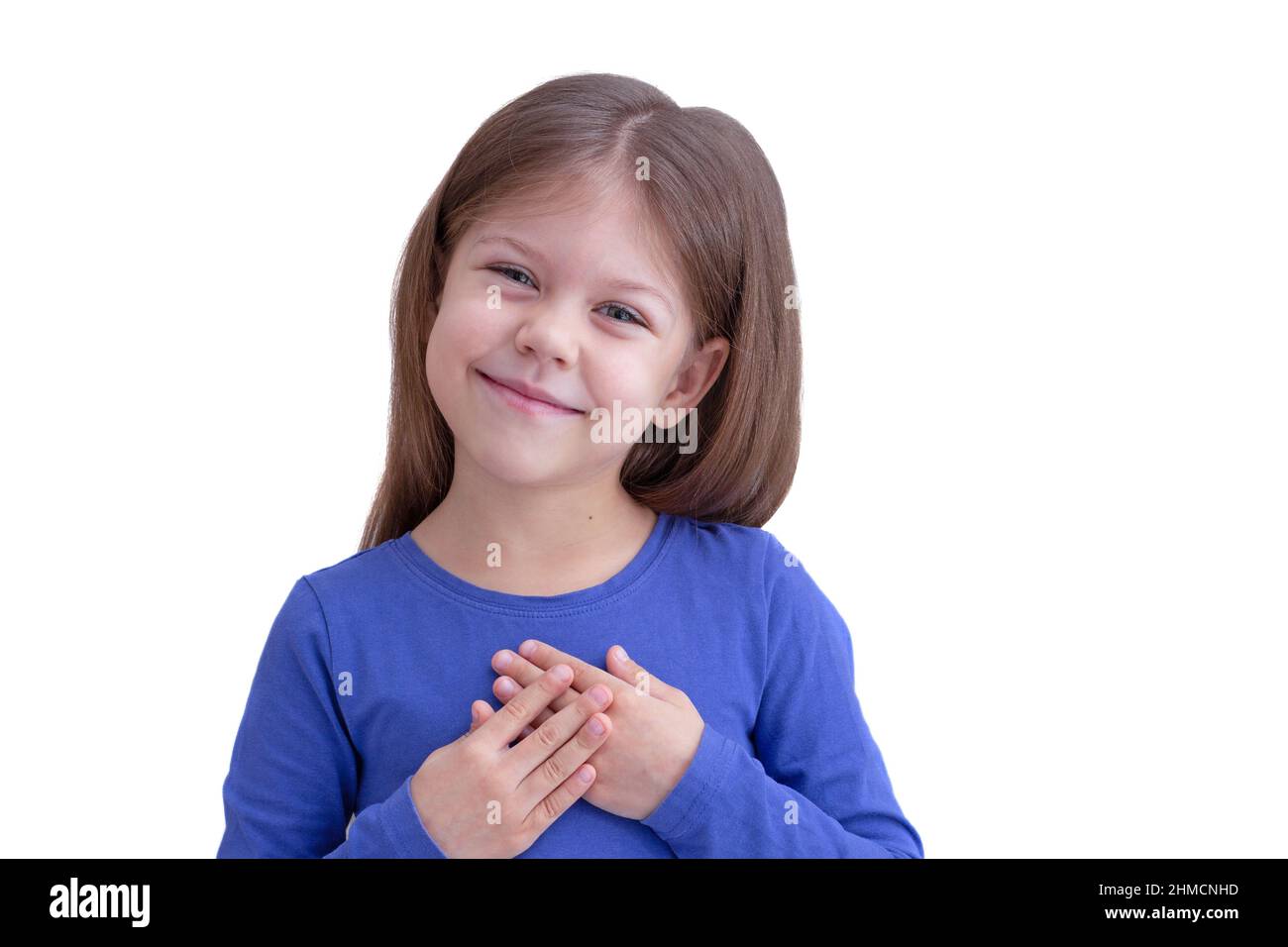 Smiling thankful child kid holding hands on heart to give you gratitude ...