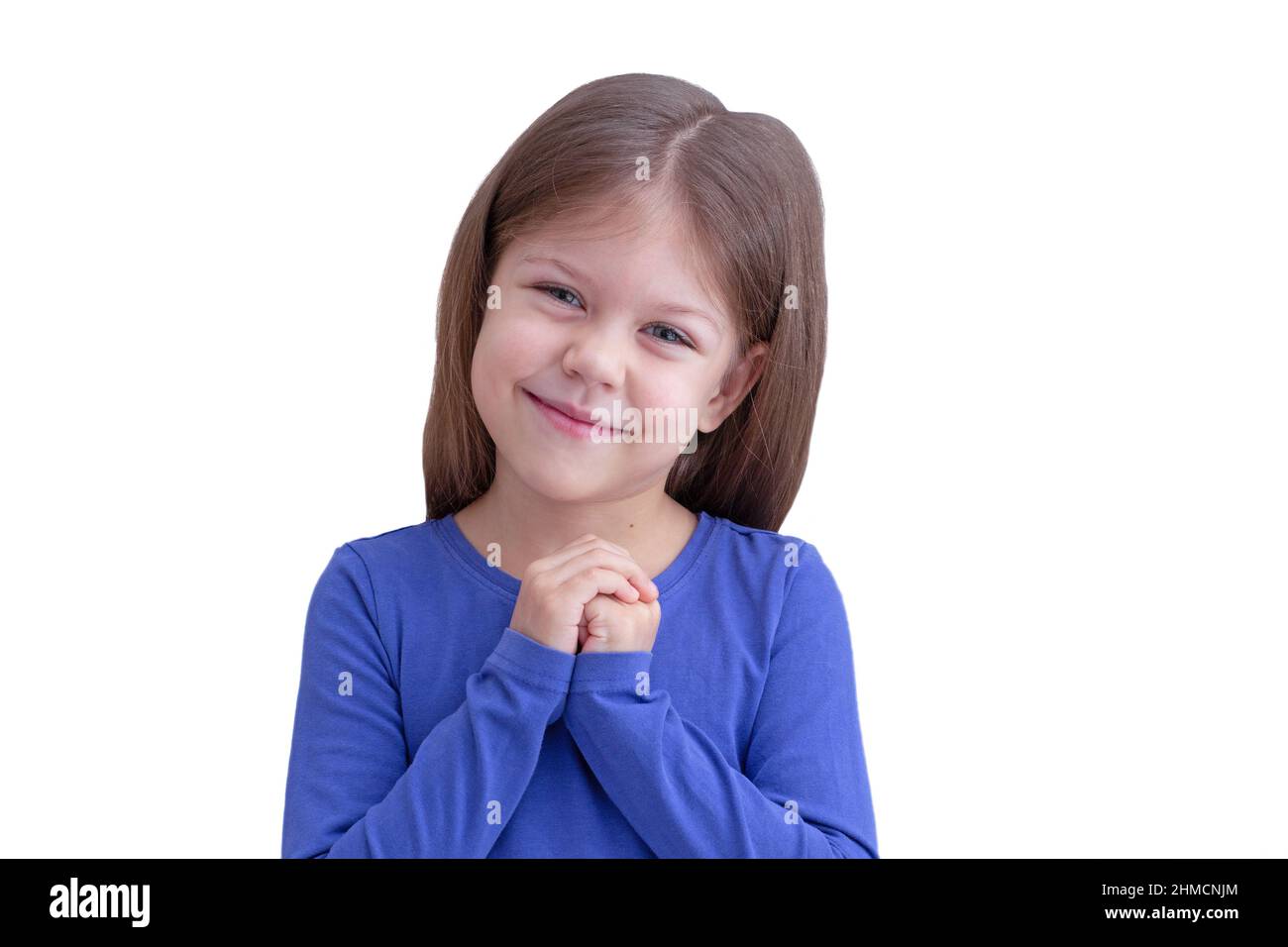 Smiling touched child kid holding hands on heart to show touchingness ...