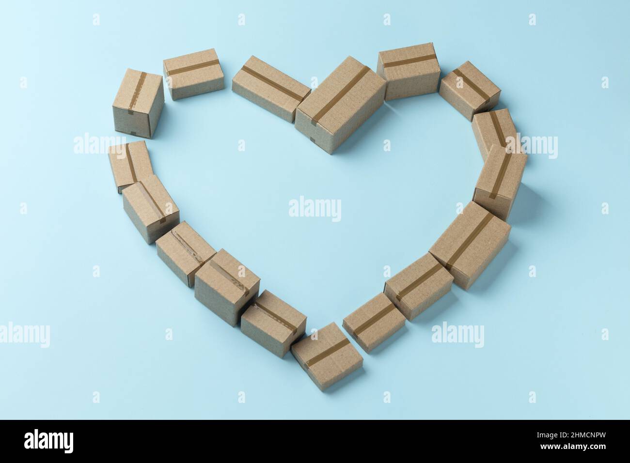 Heart symbol made from cardboard boxes on blue background. Favorite ...