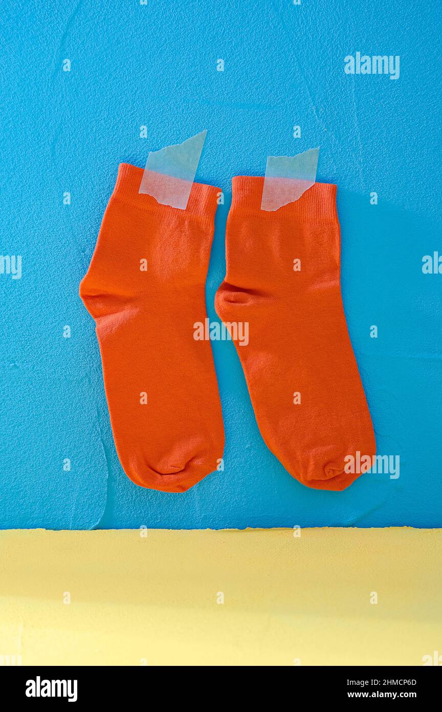 Clean socks drying. Blue background Stock Photo - Alamy