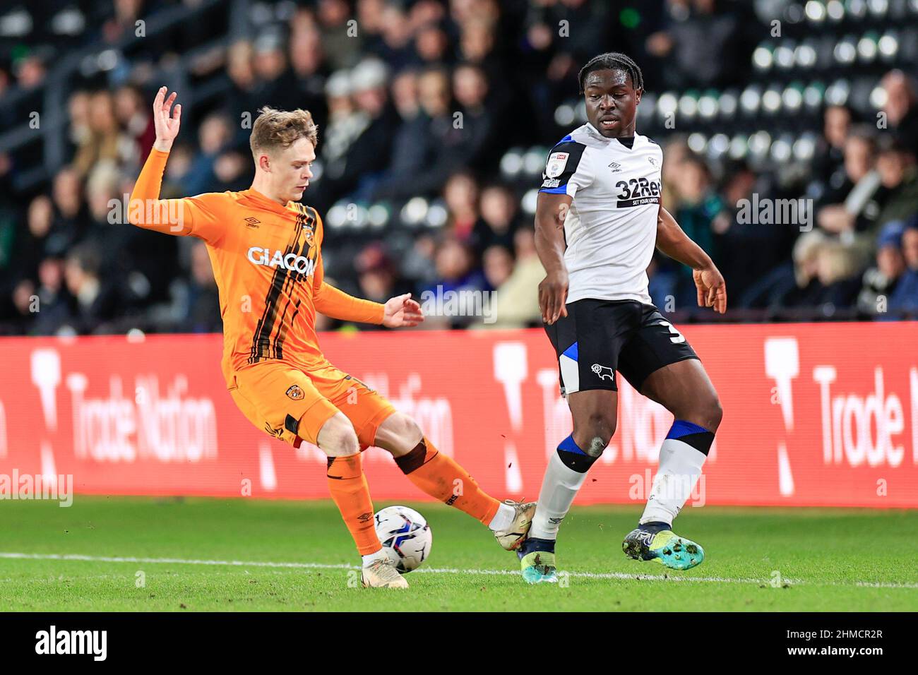 Festy Ebosele #36 of Derby County is caught on the ankle by Keane Lewis ...