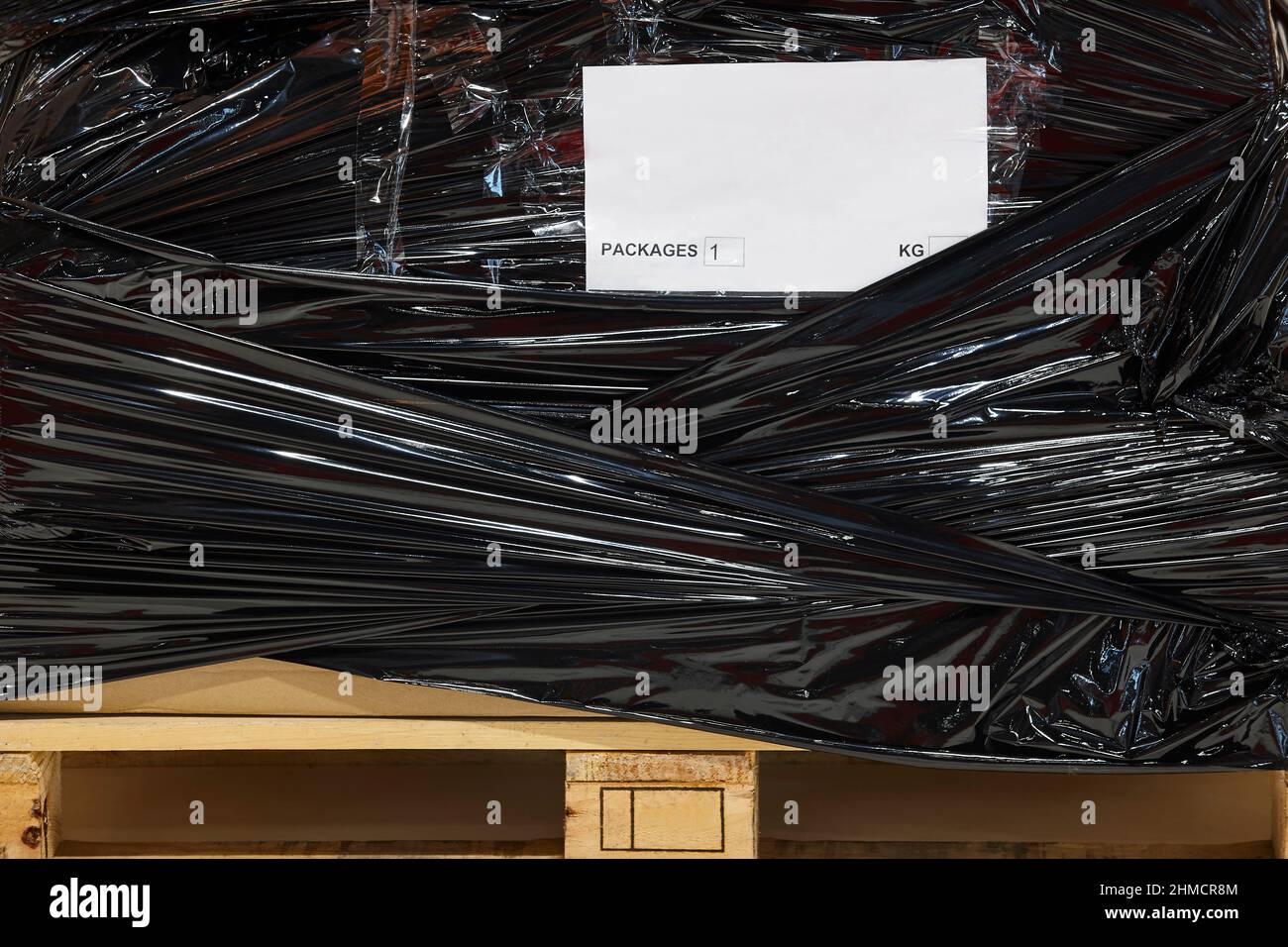 Wrapped package with black plastic. Parcel and delivery services Stock ...