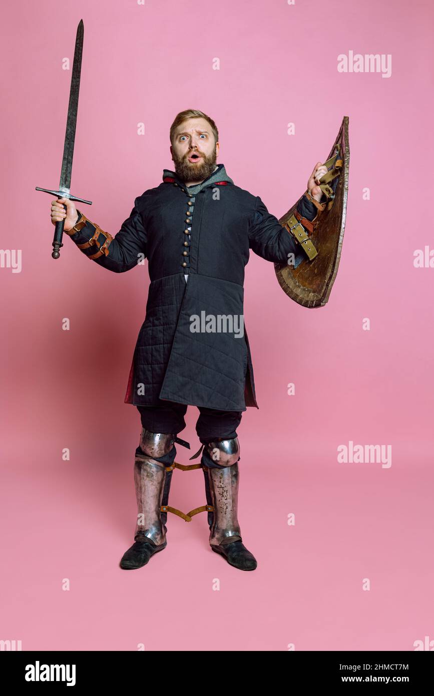 One young shocked man, medieval warrior or archer with sword and ...
