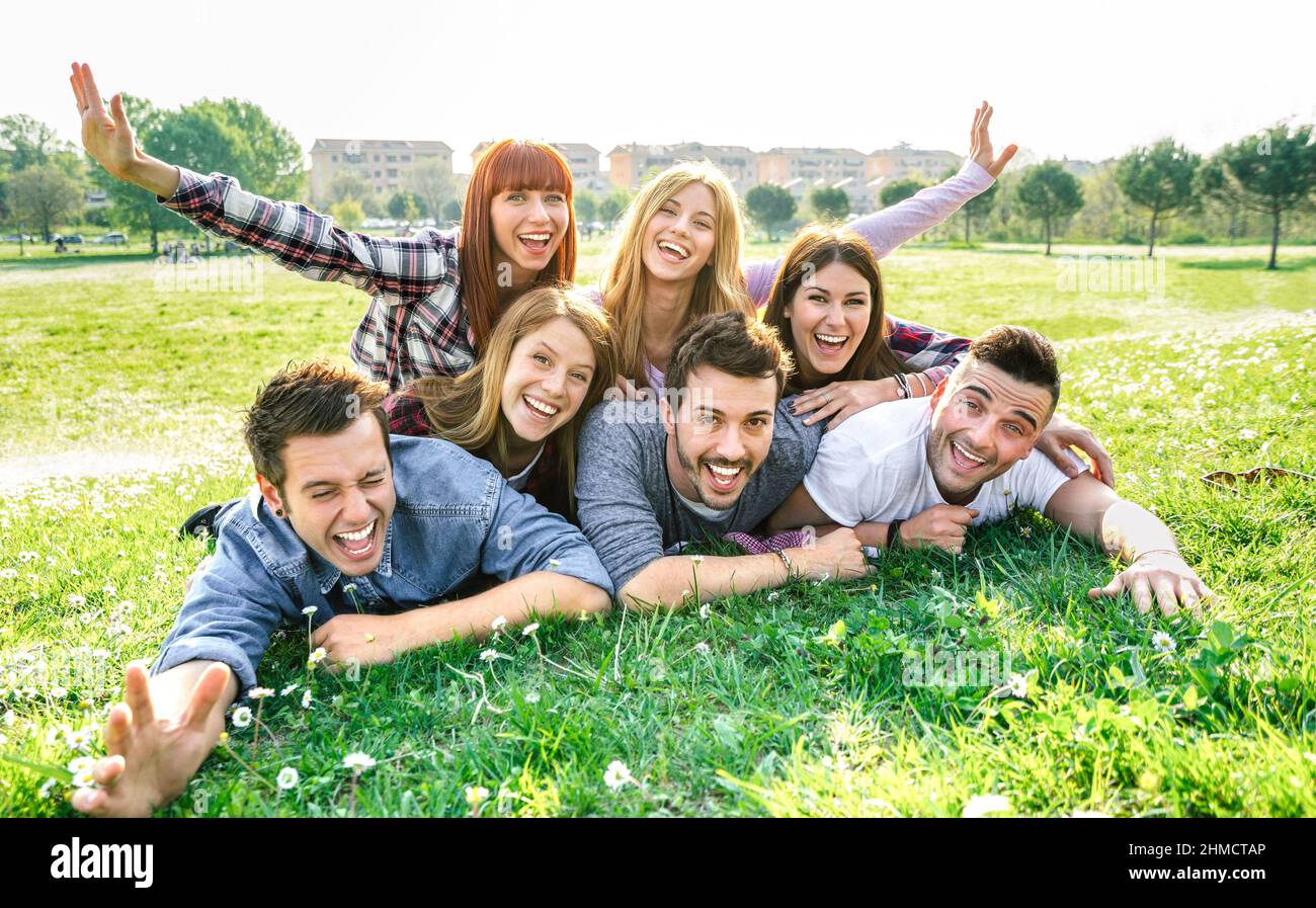 Young people having fun together with self portrait on grass meadow ...