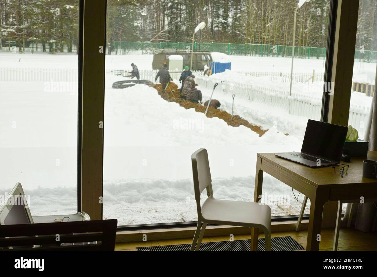 interior of a modern house and works behind a window, winter scene ...