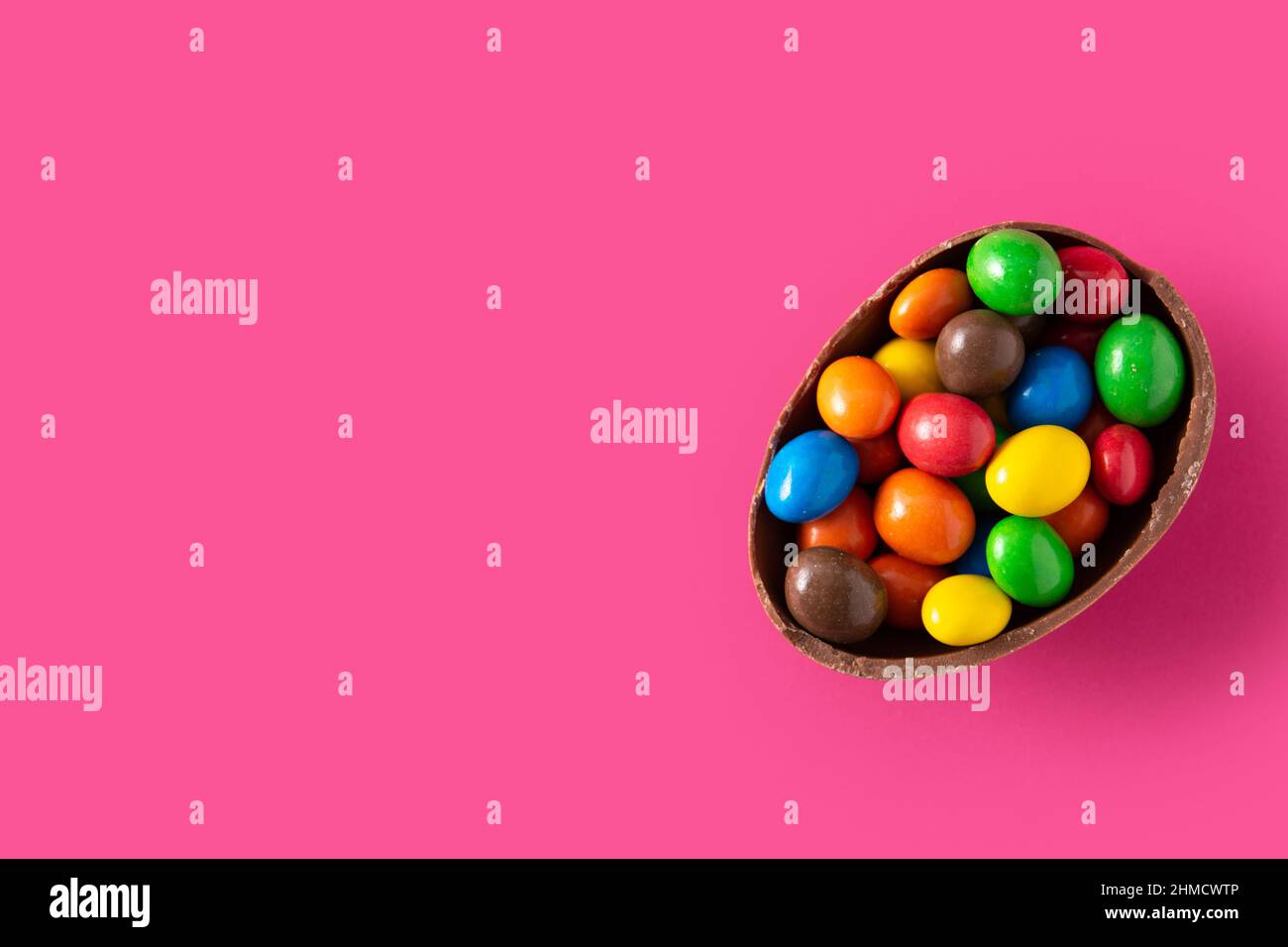 Colorful chocolate Easter eggs on pink background Stock Photo - Alamy