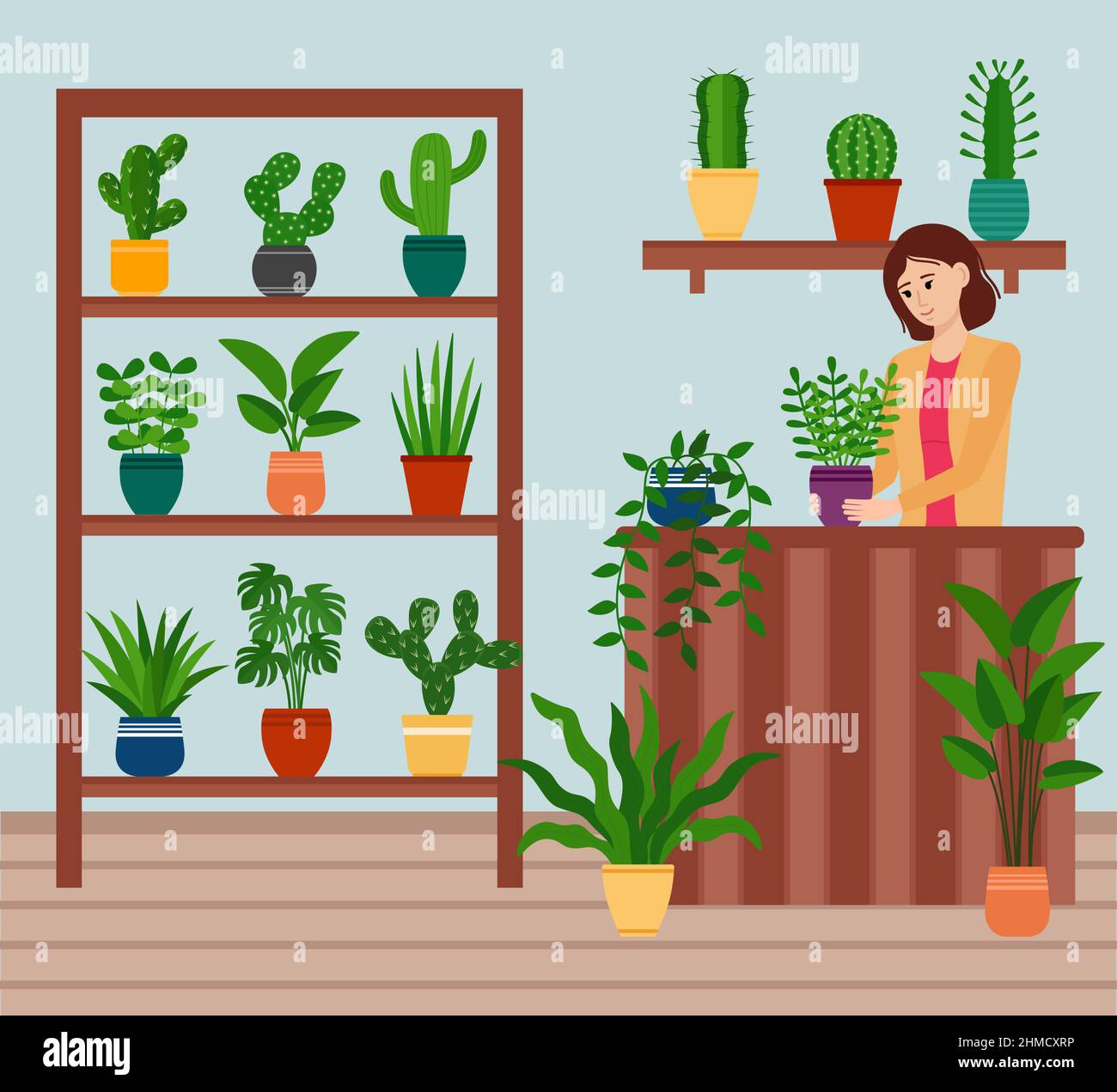 Girl shop assistant stands at the table in shop with houseplants ...