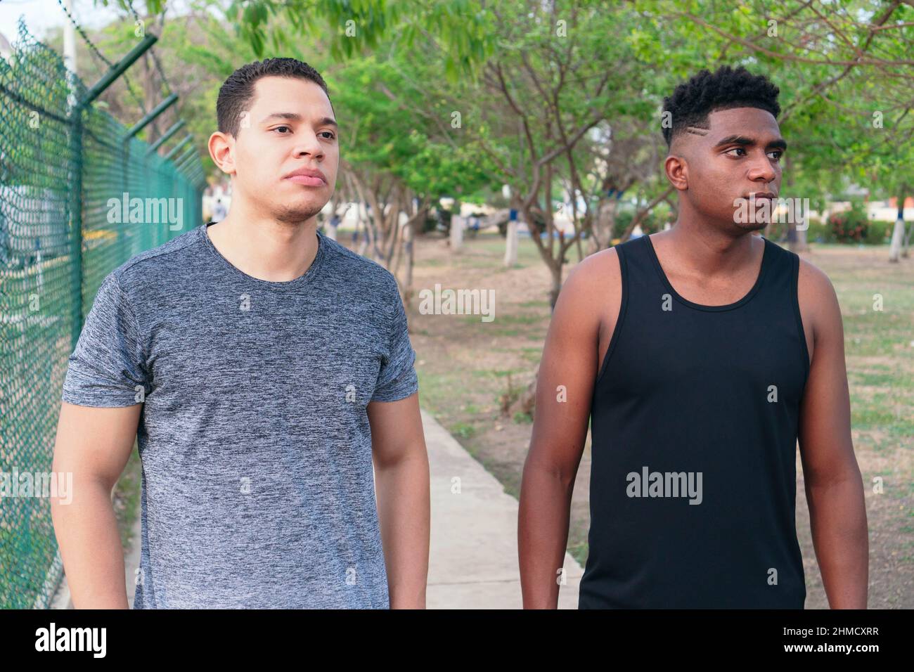 Athletic men walking together on park Stock Photo - Alamy