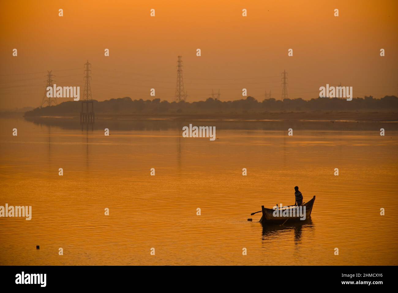 beautiful golden light sunset landscape with fisherman on the small ...