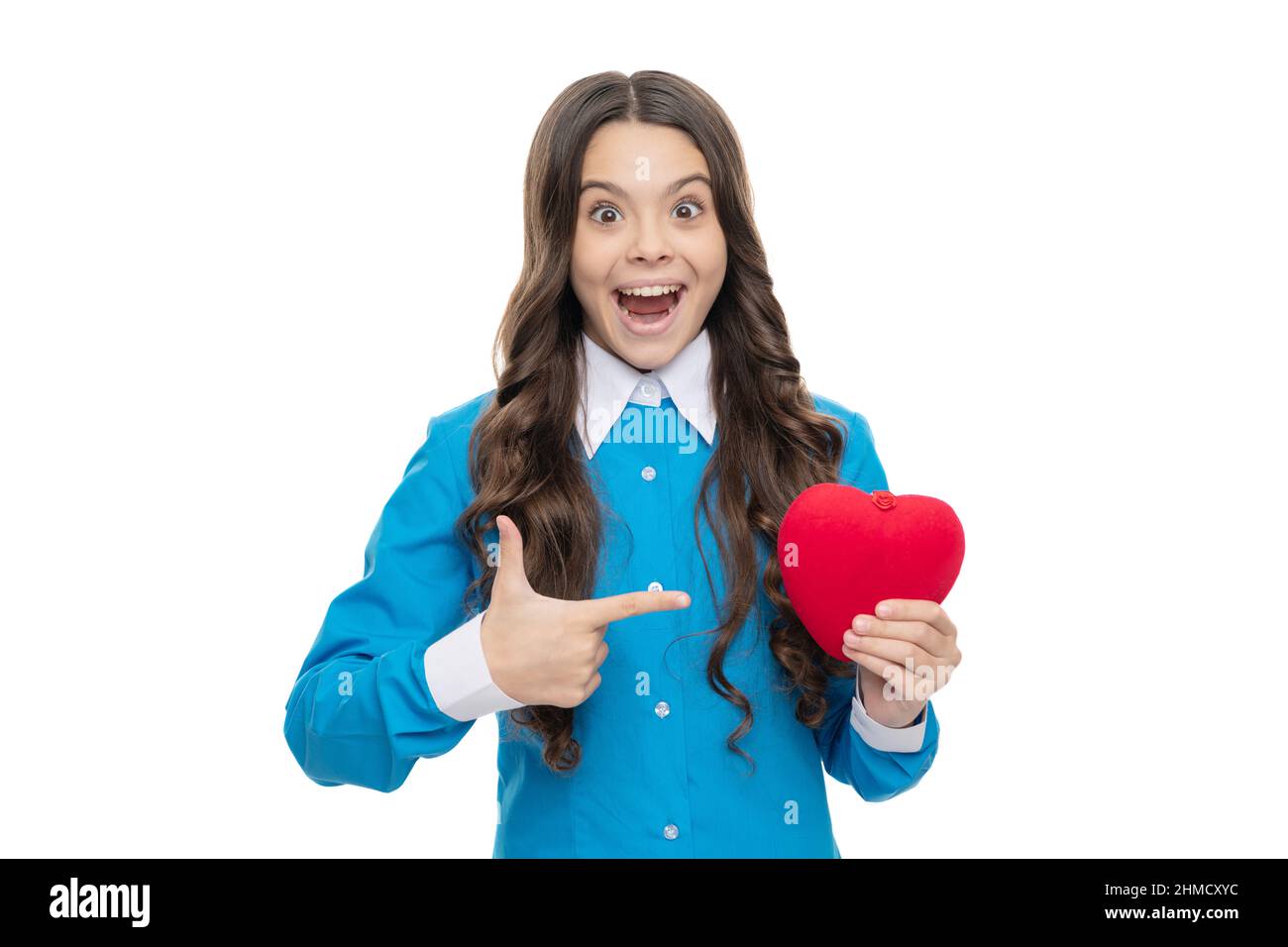 Surprised child with open mouth point index finger at red heart ...