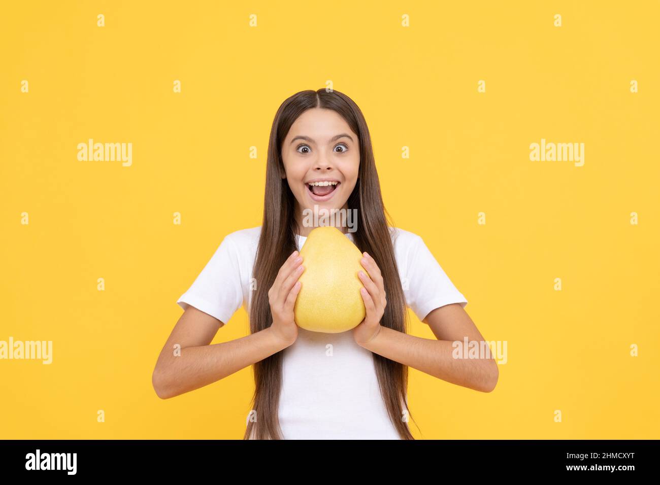 happy kid girl hold big citrus fruit of yellow pummelo or pomelo full ...
