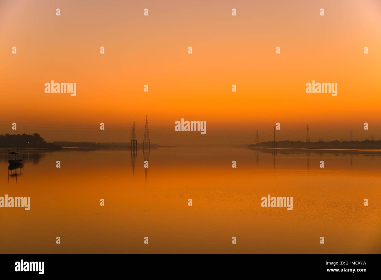 beautiful golden light sunset landscape with fisherman on the small ...