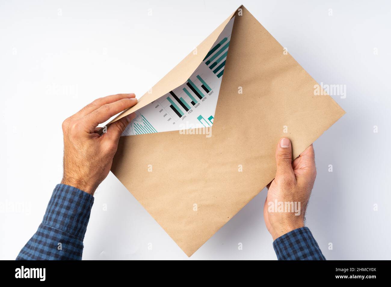 Male hands opening craft paper envelope above white surface Stock Photo ...