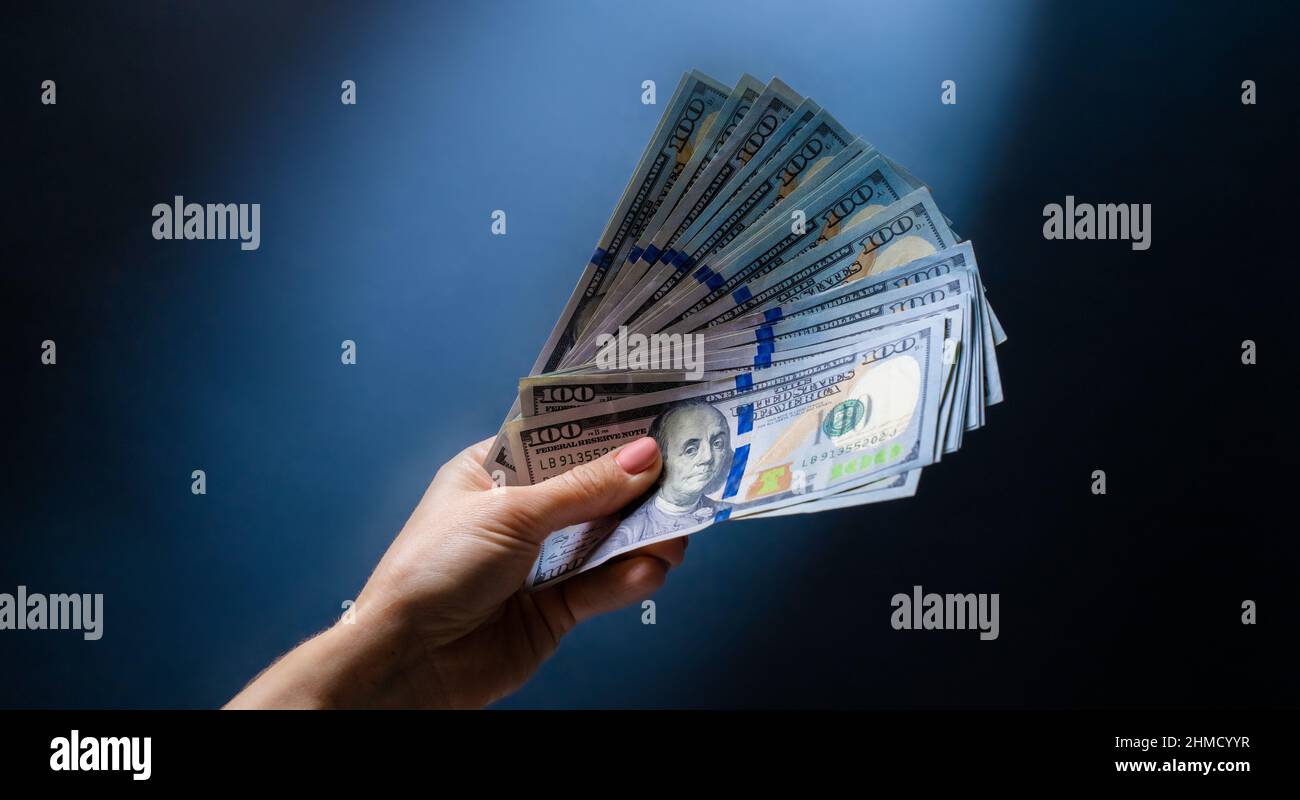 Hand holding banknotes Stock Photo - Alamy