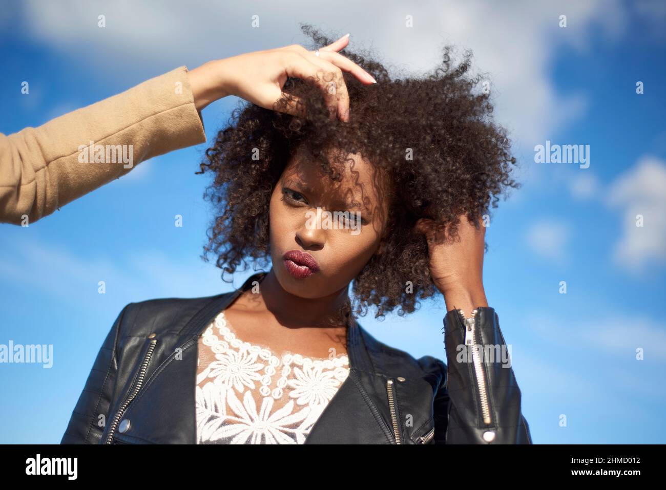 Stylist preparing a beautiful black female model for a photoshoot Stock ...