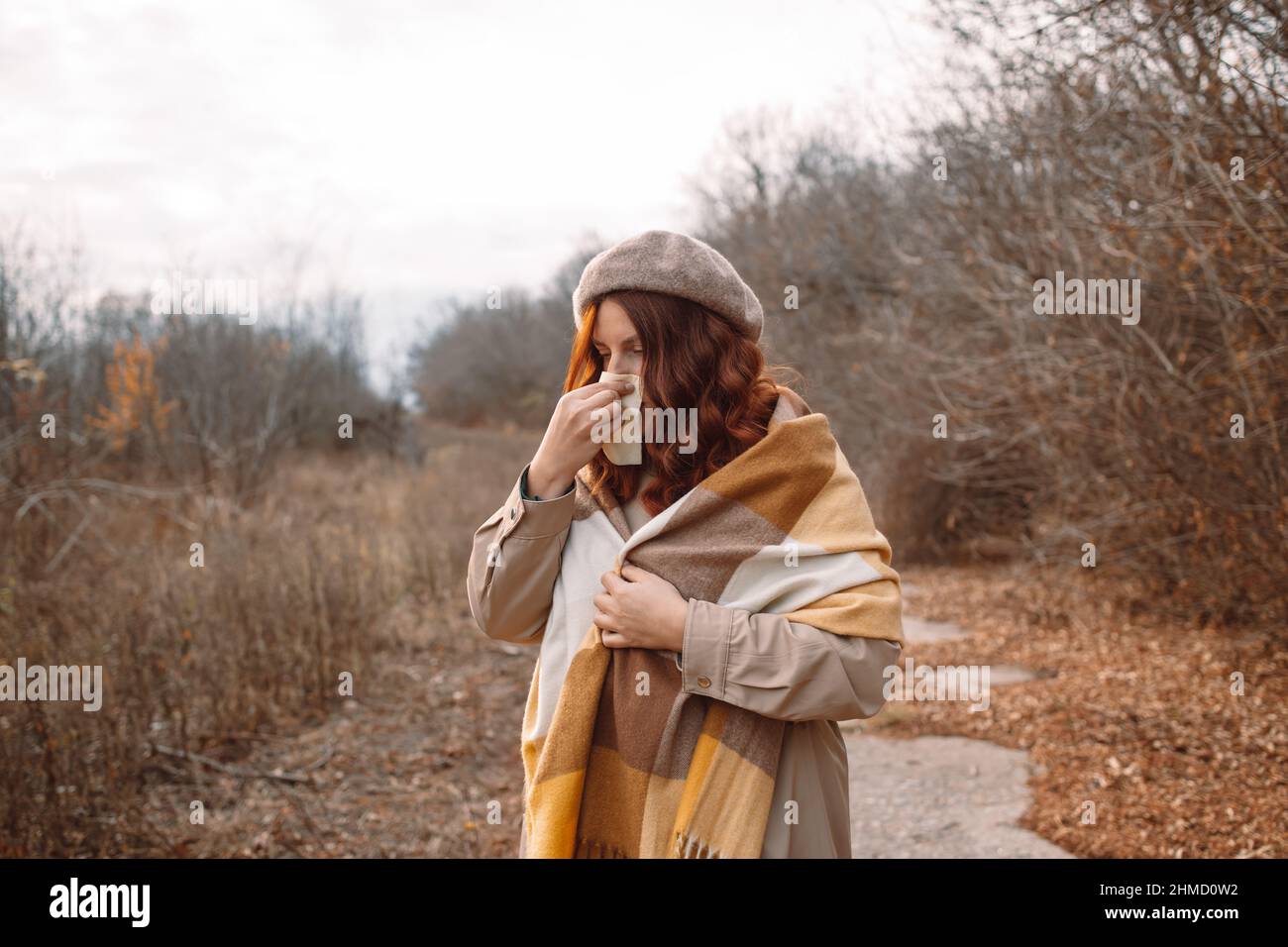 Sick young woman stand sneezing coughs feel sick at outdoor fever cold ...